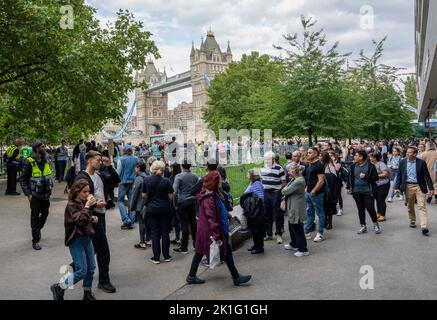 Members of the public queue back to tower bridge to pay their respects ...