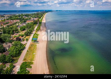 Beautiful shot of a sandy landscape with buildings on the background of ...