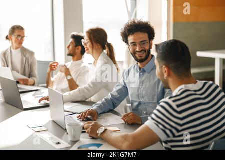 Busy coworkers cooperating and working together at office meeting ...