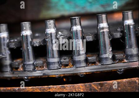 Shell casings transported by vintage equipment at plant Stock Photo - Alamy