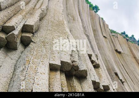 basalt columns forming a coastal rock at Cape Stolbchaty on Kunashir ...