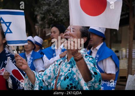 Members of the Japanese Makuya movement wave the national flags of ...