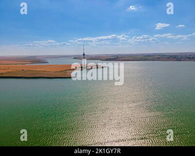 Aerial photography over Techirghiol lake with a patch of land and the ...