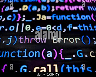 Computer code displayed on pixelated screen with colorful characters on ...