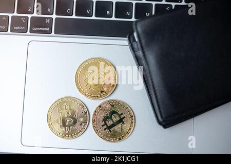 golden Cryptocurrency and wallet on keyboard laptop, Bitcoin coin ...