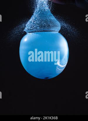 water-filled balloon at the moment of bursting when punctured Stock ...