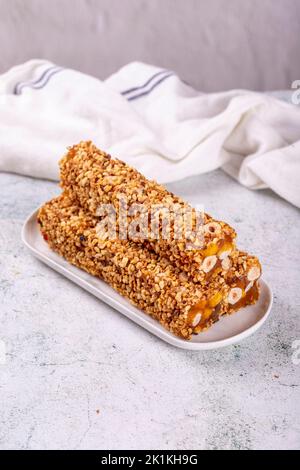 Soft coconut candy covered with hazelnuts, Egyptian cultural desserts ...