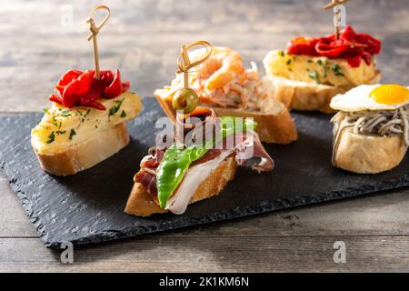 Assortment of Spanish pintxos on wooden table Stock Photo - Alamy