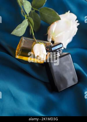 Bottles of perfume with flowers on blue background Stock Photo - Alamy