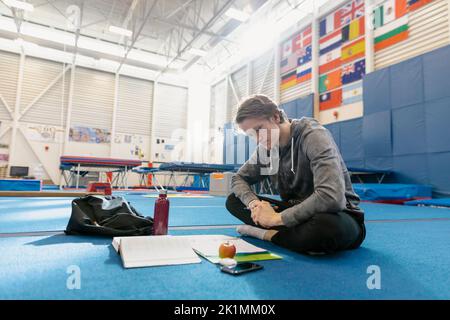 Male athlete studying in gymnasium Stock Photo - Alamy