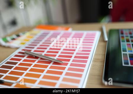 Color palette with different shades and tablet on table Stock Photo - Alamy