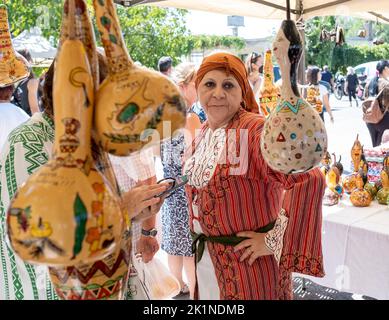 Cypriot people in traditional dress watch performers at the Statos ...