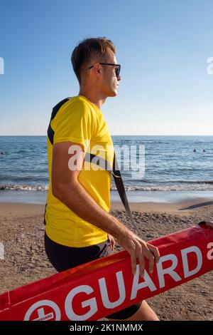 Lifeguard equipment in yellow and red colors and shark danger on the ...