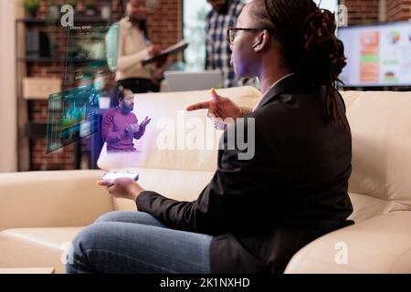 Company employee using hologram to talk to man with augmented reality ...