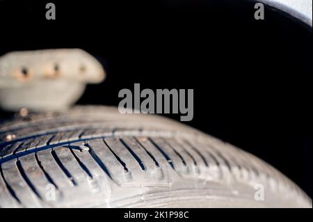 screw protruding from the tread of a tire causing a flat Stock Photo ...