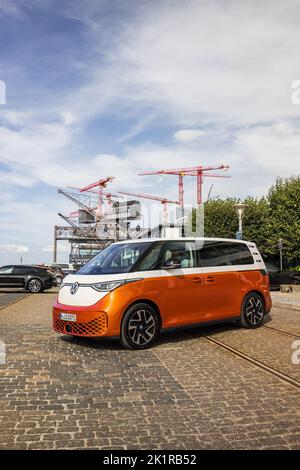 A vertical shot of an orange Volkswagen VW ID Buzz Pro modern Electric ...