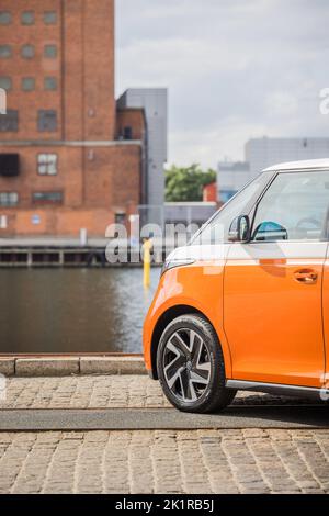 A vertical shot of an orange Volkswagen VW ID Buzz Pro modern Electric ...