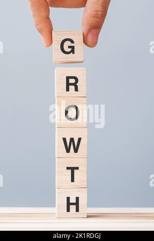 hand holding wooden cube block with 2022 text on blue background ...