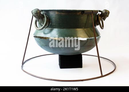 The cauldron is decorated by four cast heads of Germanic men wearing a ...