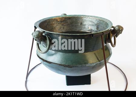 The cauldron is decorated by four cast heads of Germanic men wearing a ...