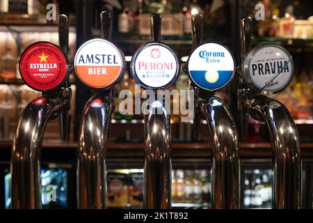 Stainless steel beer taps, craft beer in an English pub, various brands ...