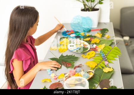 Notepad with watercolor paintings autumn leaves. View of workplace ...