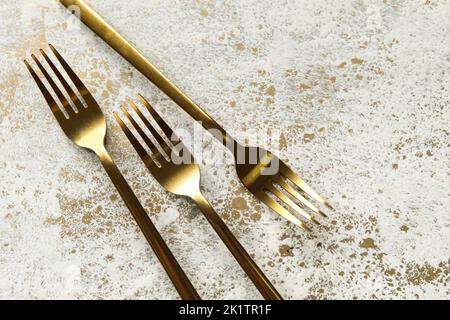 Golden forks on grunge background Stock Photo - Alamy