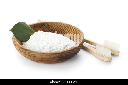 Bowl of tooth powder with leaf, brushes in holder, soap dispenser and ...