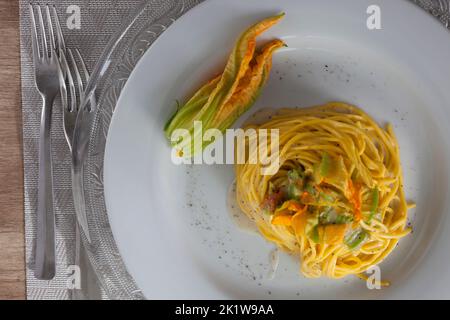 Creamy spaghetti with zucchini flower Stock Photo - Alamy