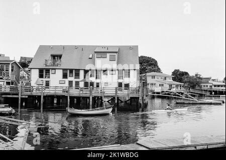 Private docks and pier with kayaker paddling on rocky neck Gloucester ...