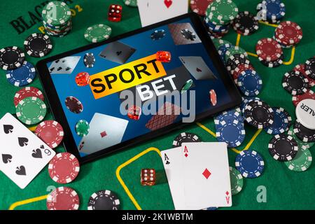 Smartphone with poket table on screen, playing cards and chip cards on ...