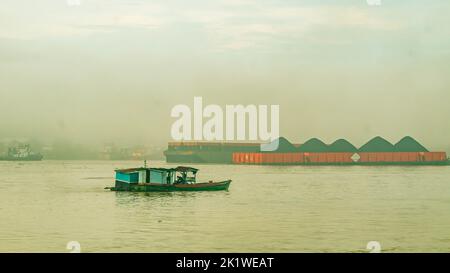 Sand miner activity at Mahakam River, Samarinda in the morning. Wooden ...