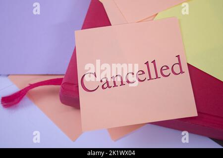 Cancelled. Text on adhesive note paper. Event, celebration reminder ...