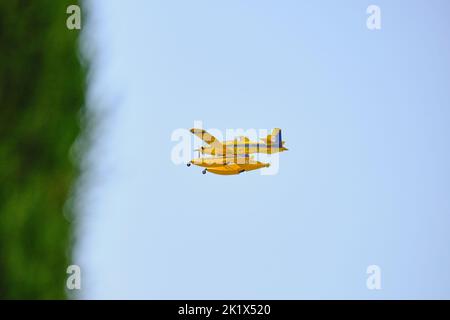 A yellow hydroplane flying in clear blue skies Stock Photo - Alamy
