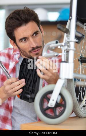 female mechanic fixing a wheelchair Stock Photo - Alamy