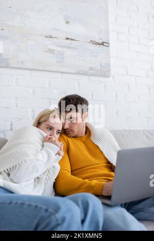 Image of a young couple, frightened man and woman, holding hands near ...