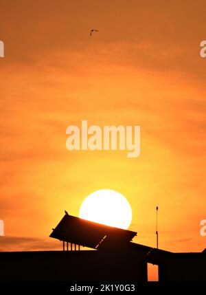 The Sun rising over solar panel on rooftop/Ahmedabad Stock Photo - Alamy