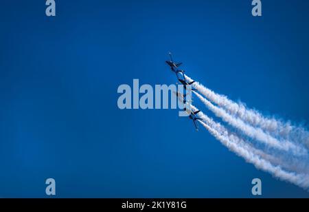 A beautiful view of four fighter jets with smoke trailing in the air ...