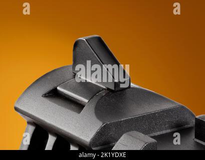 Post sight on the front of a pistol with orange background and drop ...