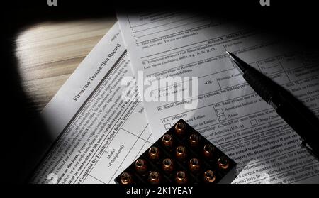 Public domain FBI NICS background check form with a pen and ammunition ...