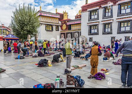 Tibetan buddhist pilgrims undertake the Kora clockwise circumambulation ...