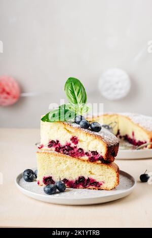 Lemon blueberry cake slice in a plate over wooden table Stock Photo - Alamy