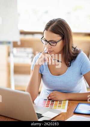 Young female graphic designer with color palettes in office Stock Photo ...