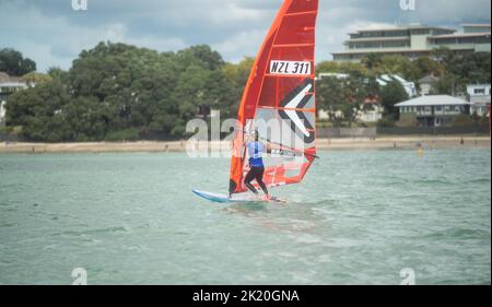 A woman competes in a national windsurfing hydrofoil race at the ...