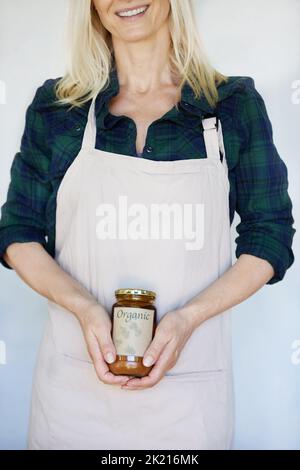 From my kitchen to yours. a person holding a jar of freshly made jam ...