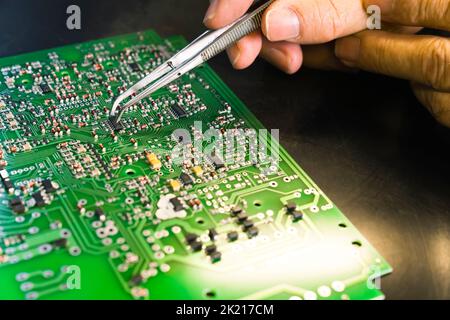Technician replacing electronic control board inside disassembled ...