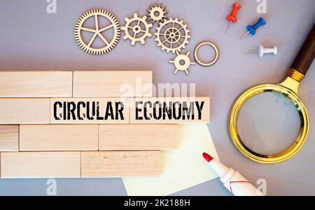circular economy symbol on paper cutout with perfect green grass ...