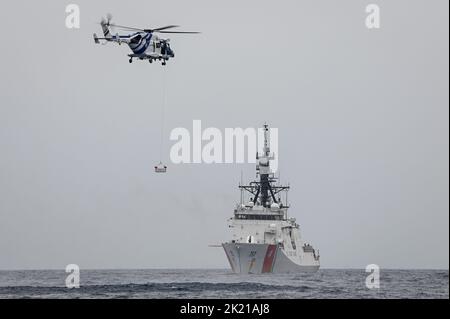 U.S. Coast Guard Cutter Midgett (WMSL 757) transits alongside the ...