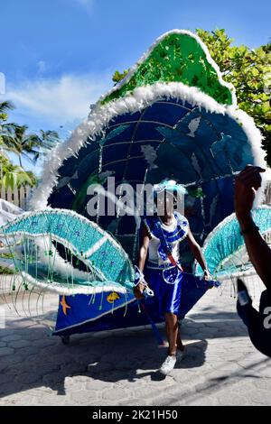 A male, Belizean dancer in an elaborate, blue, underwater-themed ...