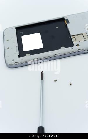 The situation of repairing a cell phone using a screwdriver tool Stock ...